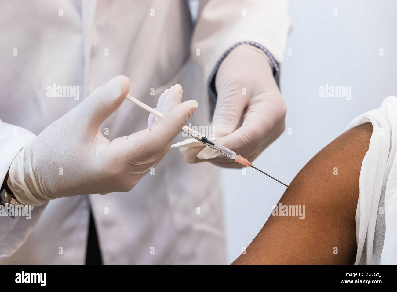 Close up of crop medic making injection for black female patient Stock ...