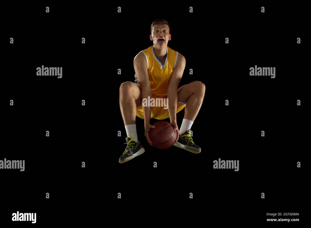 Jump shot. Basketball player with a ball in action and motion isolated ...