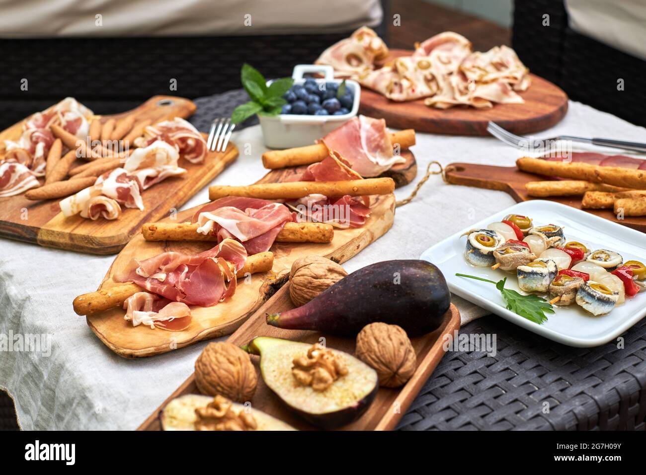 Table set up on a terrace with various delicious appetizers such as ...
