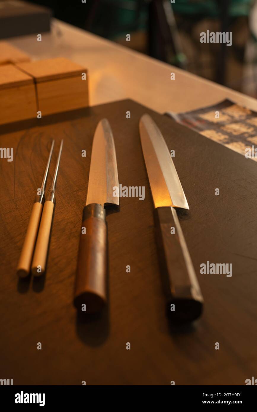 Sharp knives placed on wooden table in Asian restaurant Stock Photo - Alamy
