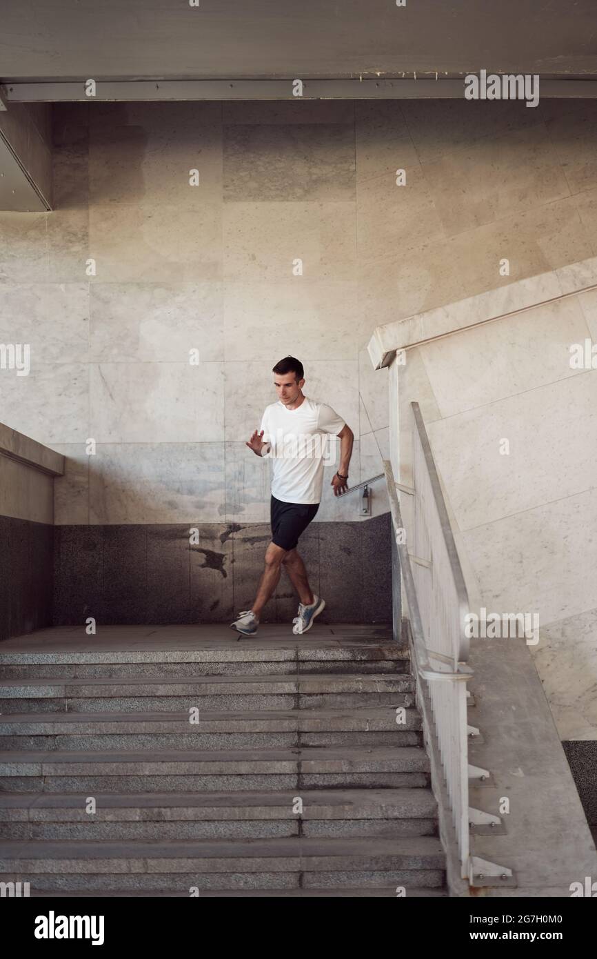 Man running downstairs hi-res stock photography and images - Alamy
