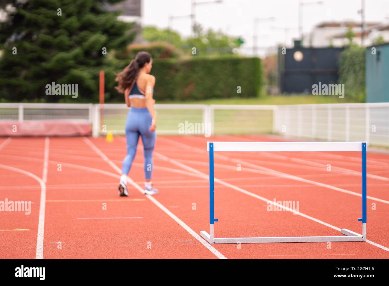 Back view of unrecognizable female athlete walking at stadium near ...