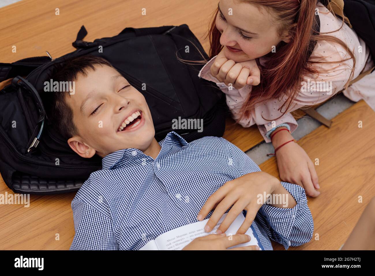 Children and schoolchildren have fun after school with backpacks on ...
