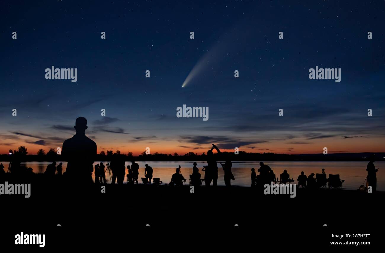 Comet Neowise and crowd of people silhouetted by the Ottawa river ...