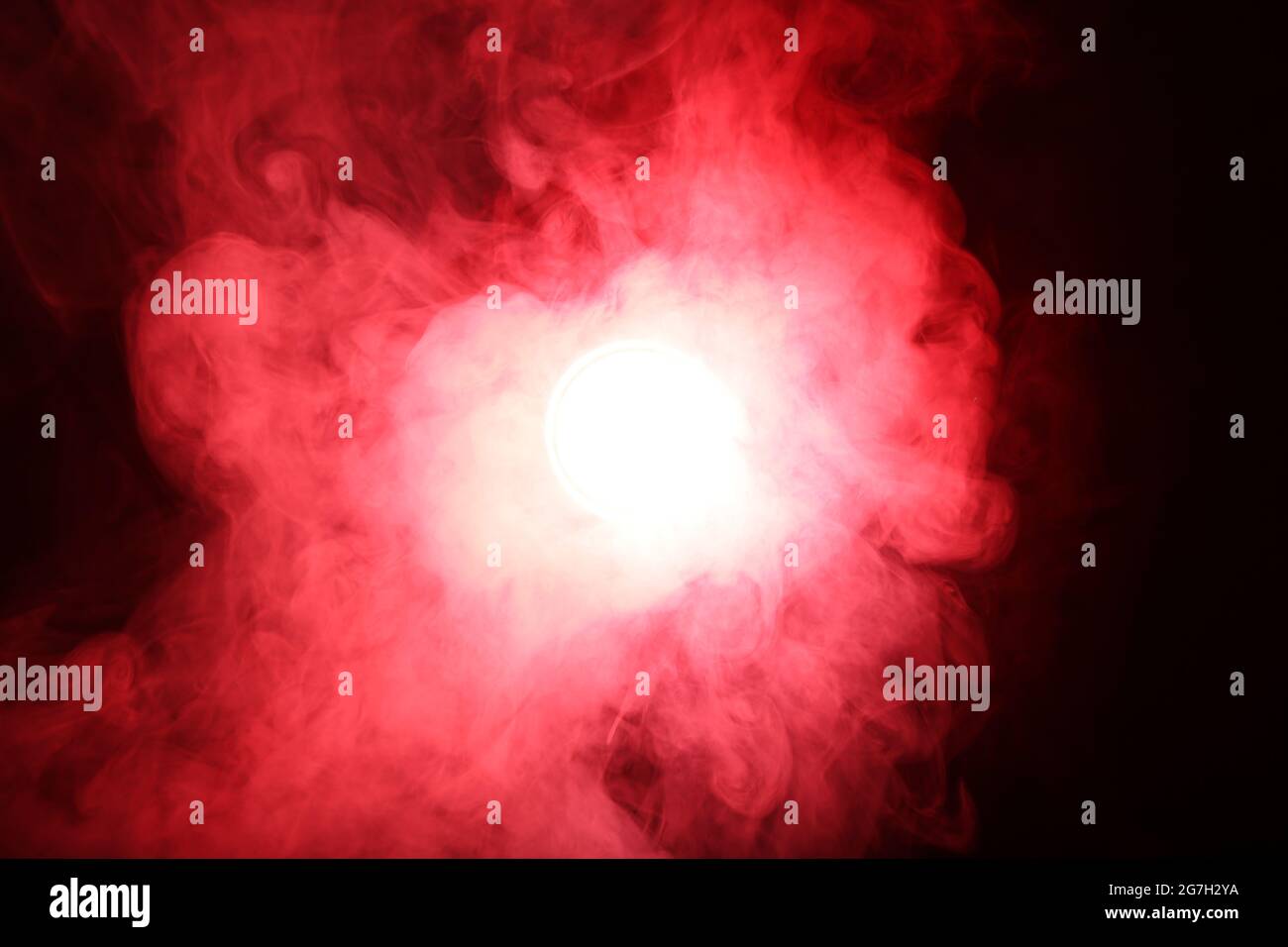 Smoke in red light on black background Stock Photo - Alamy