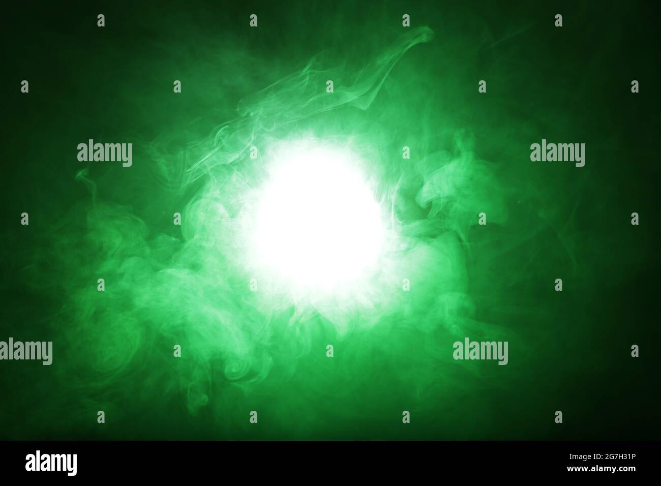 Smoke in green light on black background Stock Photo - Alamy