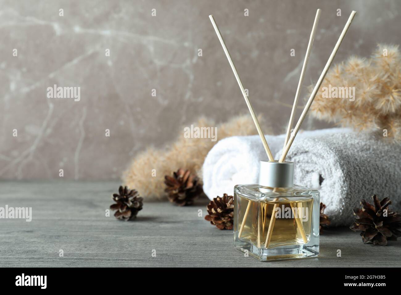 Diffuser and bath accessories on gray textured table Stock Photo - Alamy