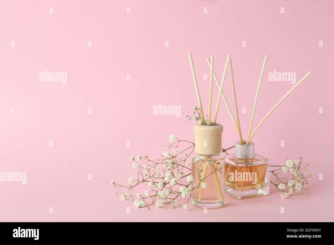 Aromatic concept with diffusers on pink background Stock Photo - Alamy