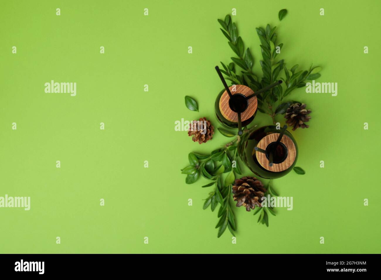 Aroma scent diffusers, cones and leaves on green background Stock Photo ...