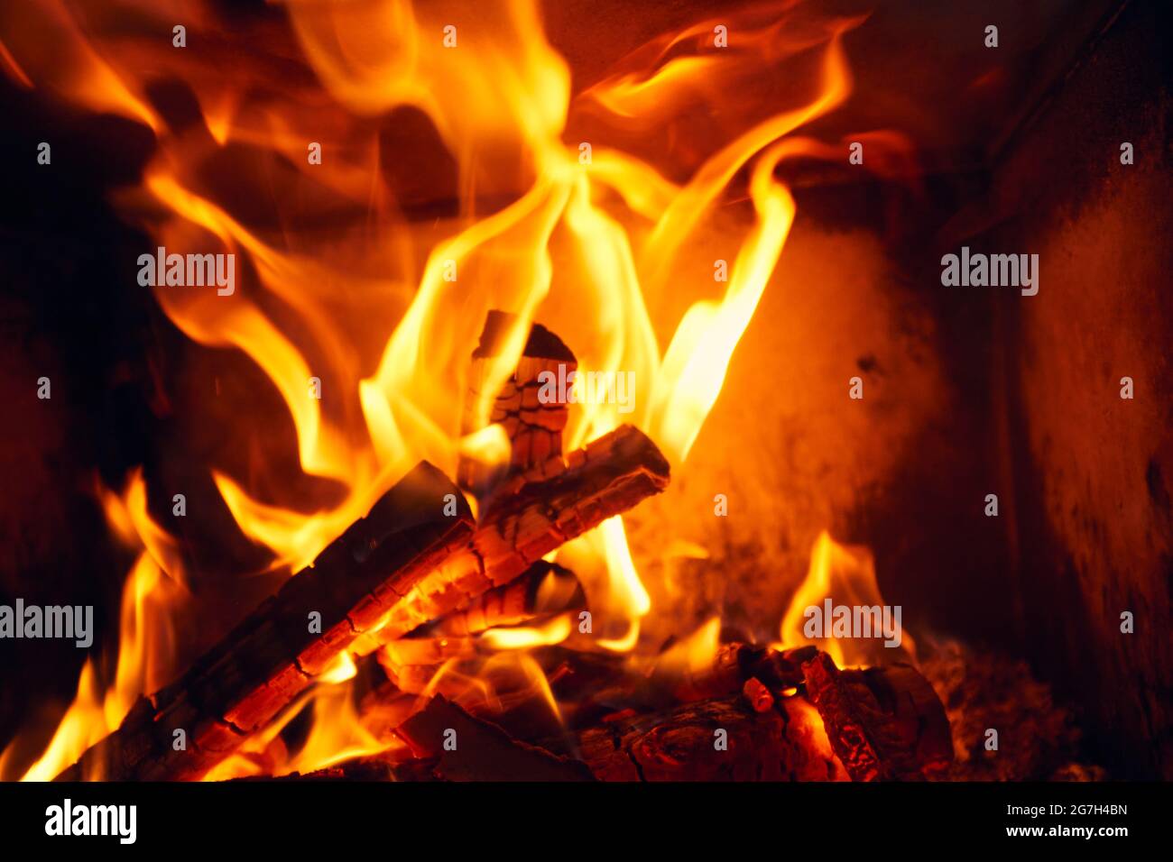 A fire burns in a fireplace, Fire to keep warm Stock Photo - Alamy