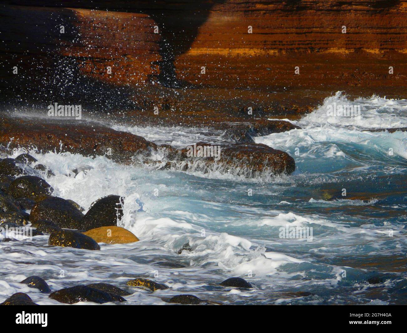 wave at rocky beach with sand cliff at background, Tenerife, Spain ...