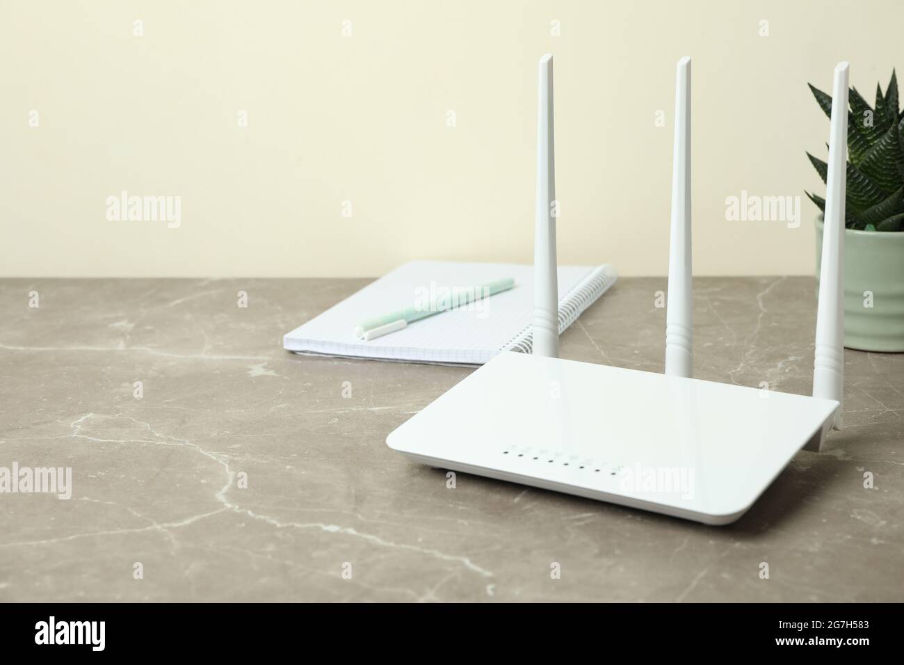 Workplace with Wi - fi router on gray textured table Stock Photo - Alamy