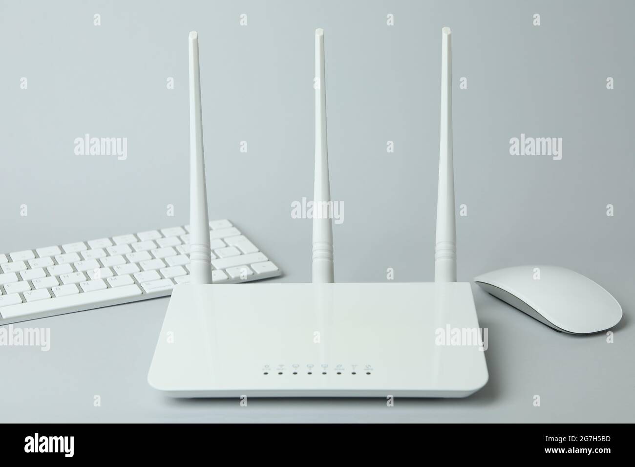 Workplace with Wi - fi router on gray background Stock Photo - Alamy