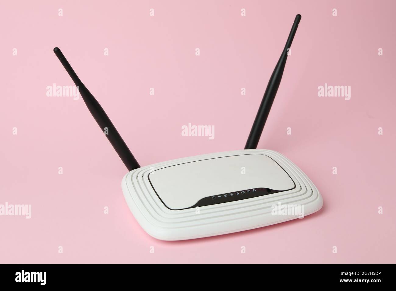 Wi-Fi router with external antennas on pink background Stock Photo - Alamy