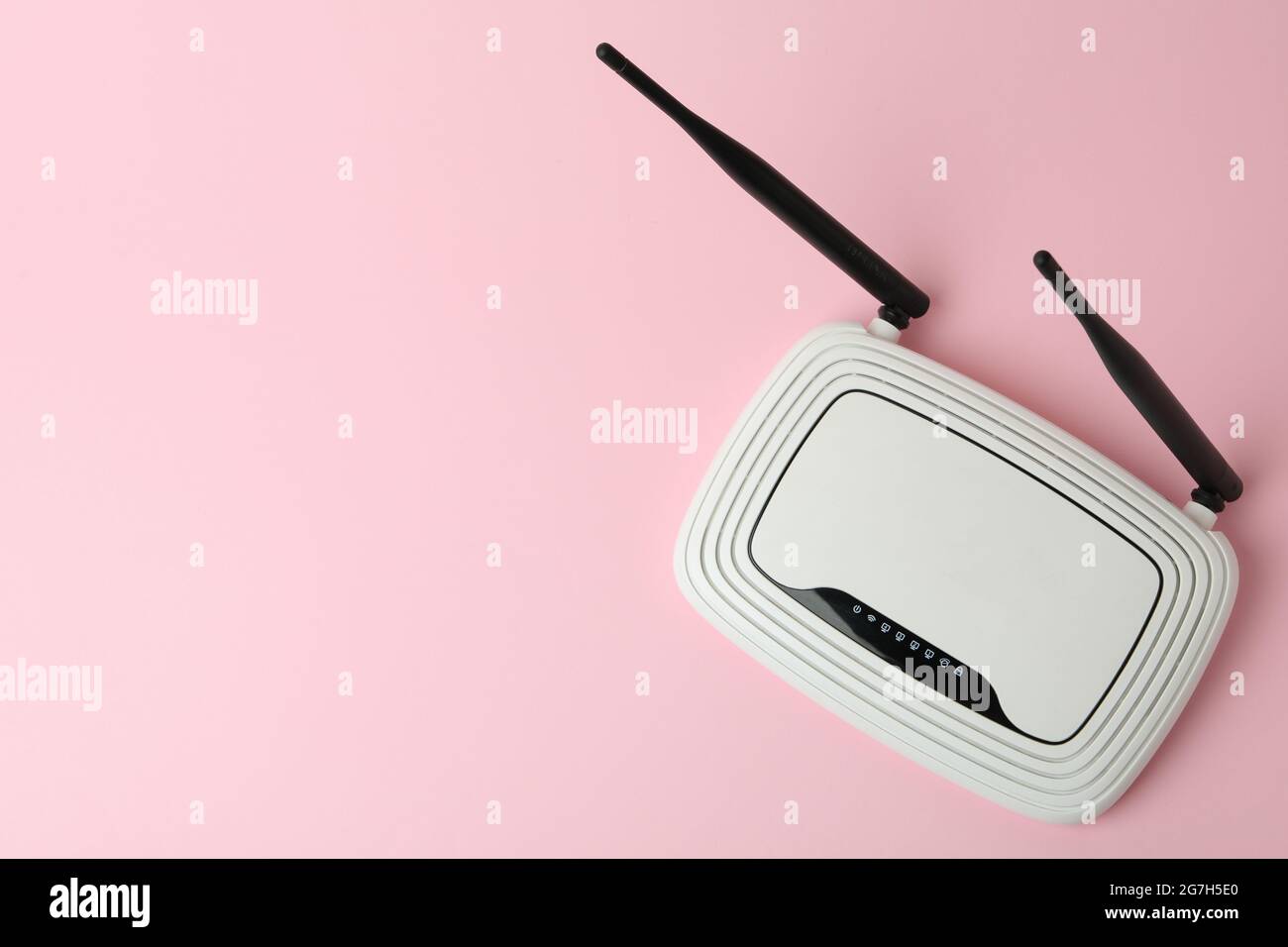 Wi-Fi router with external antennas on pink background Stock Photo - Alamy