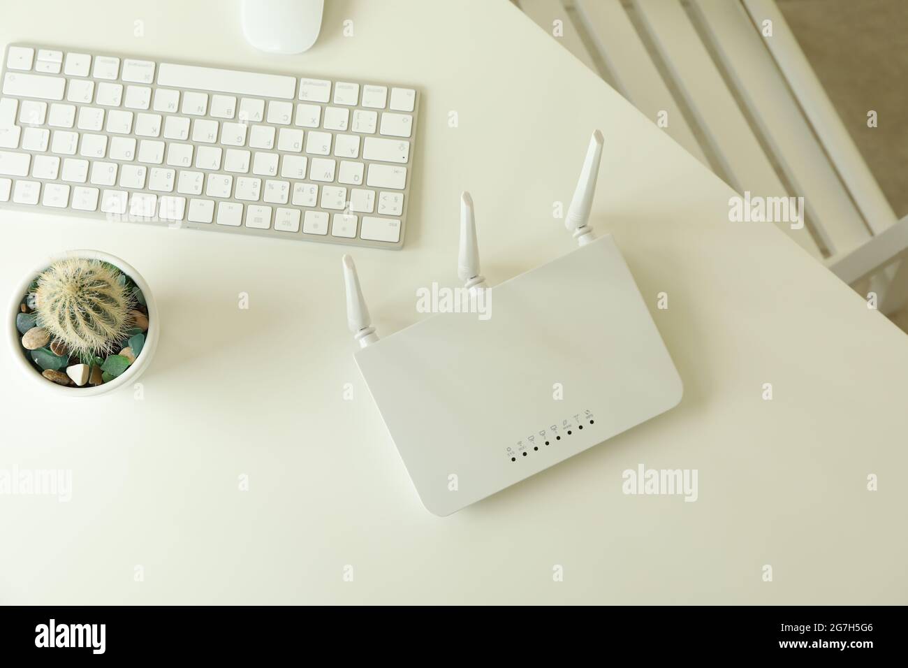 Workplace with Wi - fi router on white table Stock Photo - Alamy