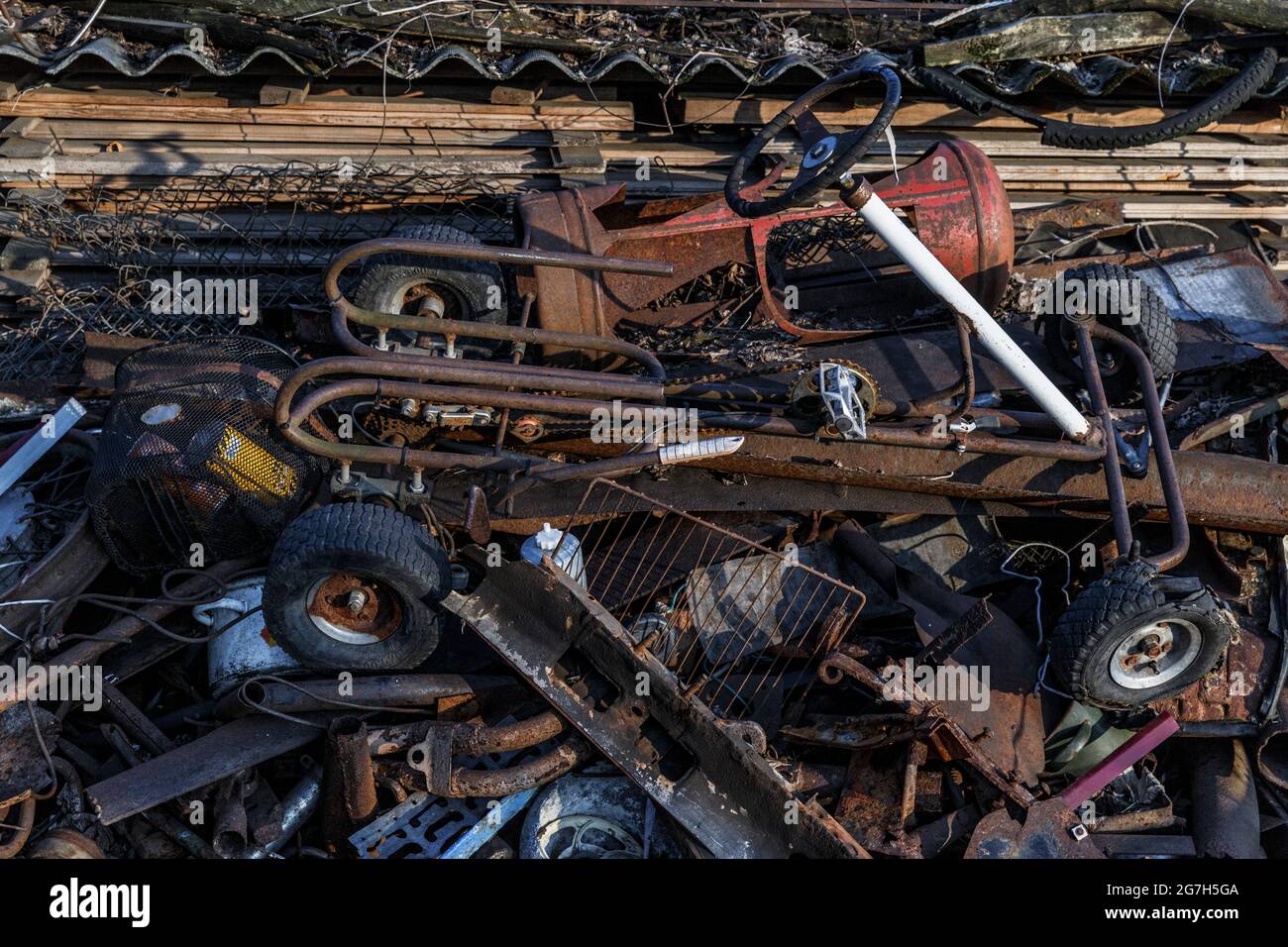 Scrap metal waste is stored in a recycling yard. Heap of scrap metal ...