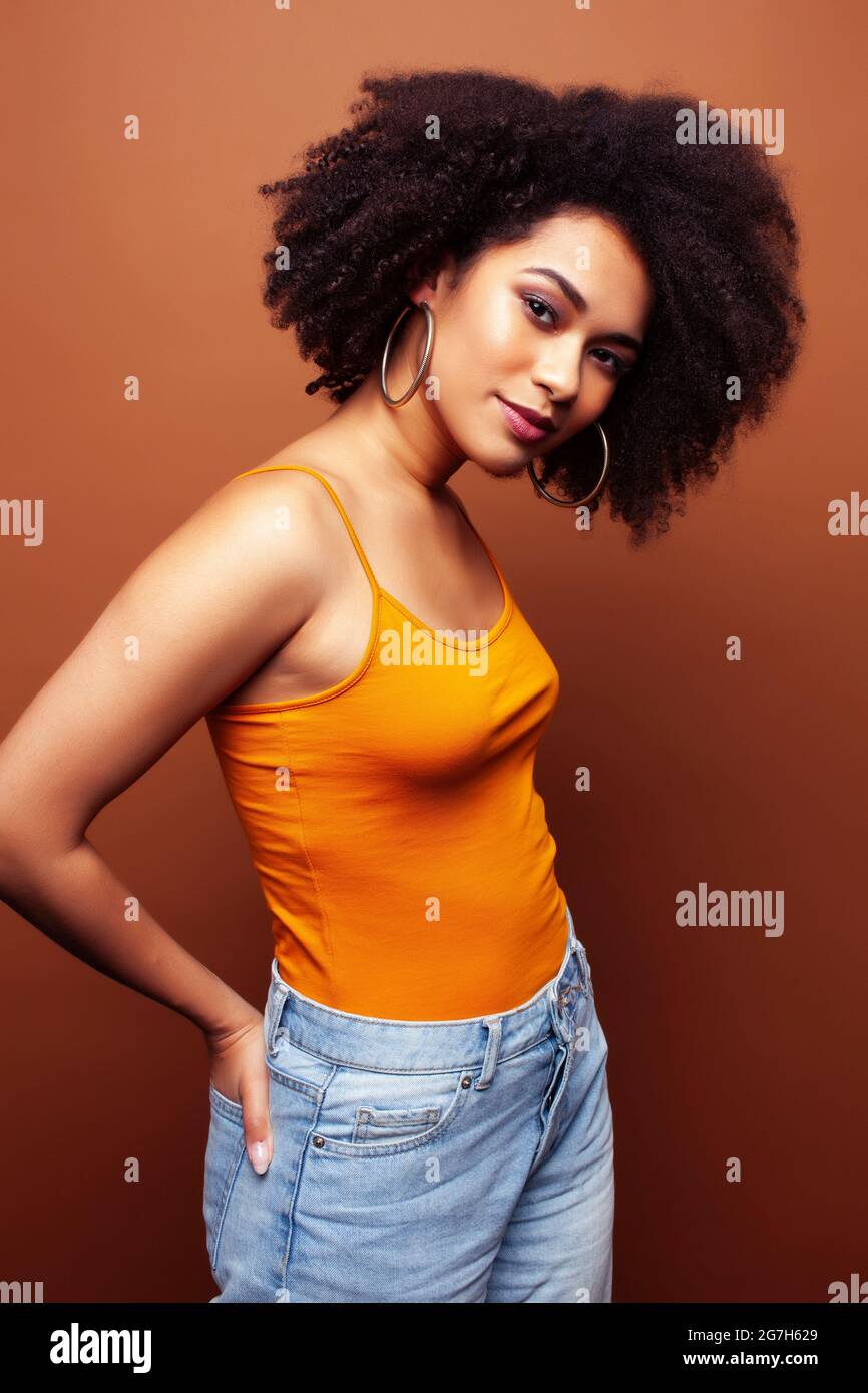 pretty young african american woman with curly hair posing cheerful ...