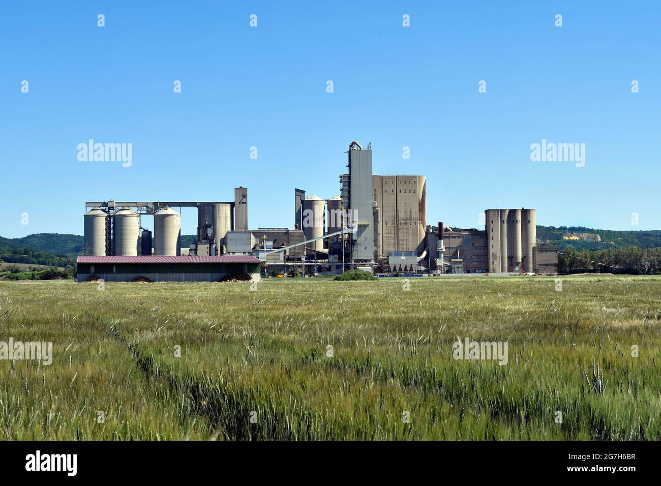 Austria, cement plant with silos and grain field in foreground Stock ...