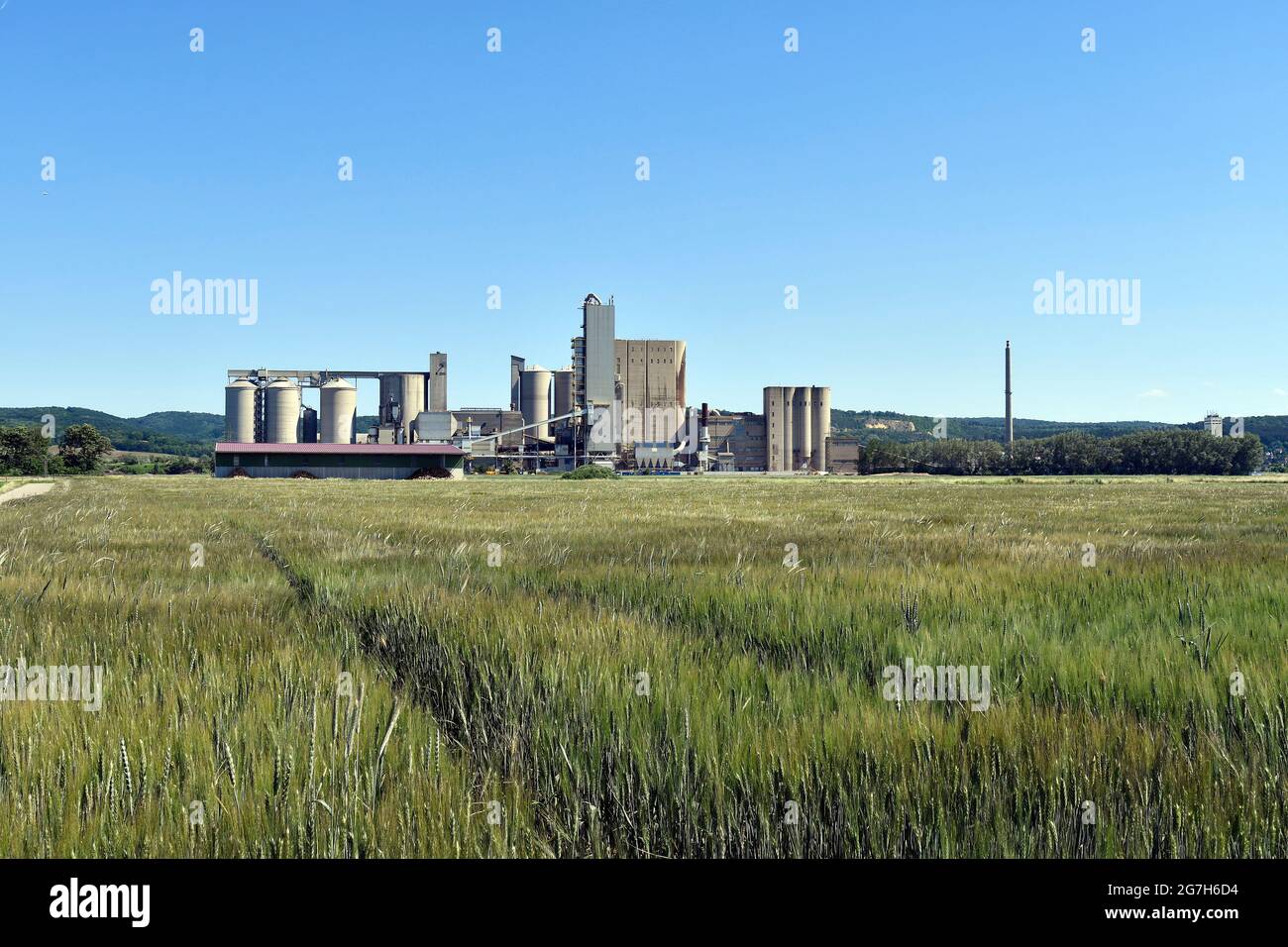Austria, cement plant with silos and grain field in foreground Stock ...