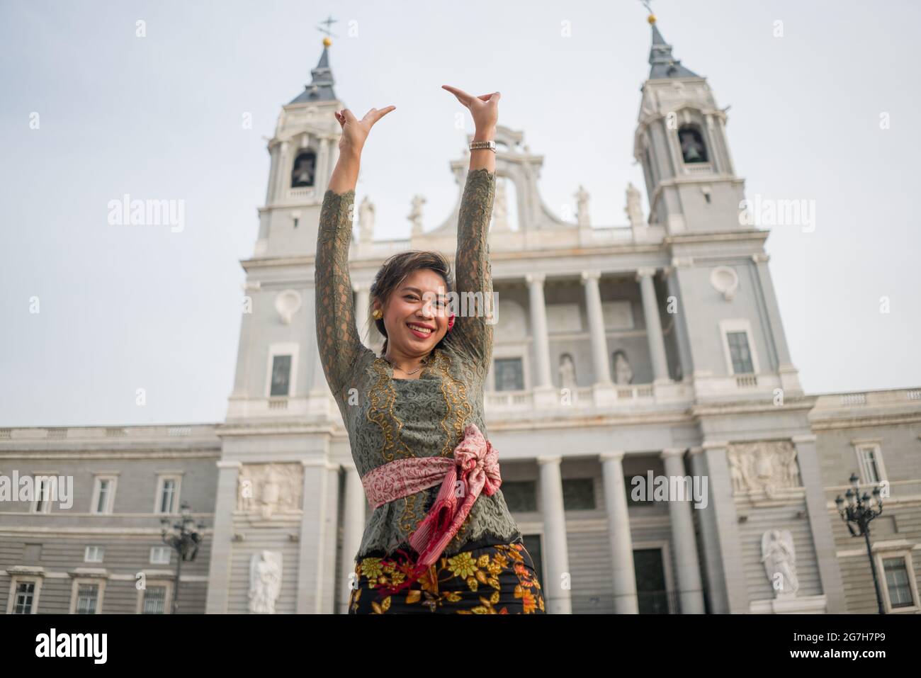 young happy Indonesian woman from Bali having vacation in Europe ...
