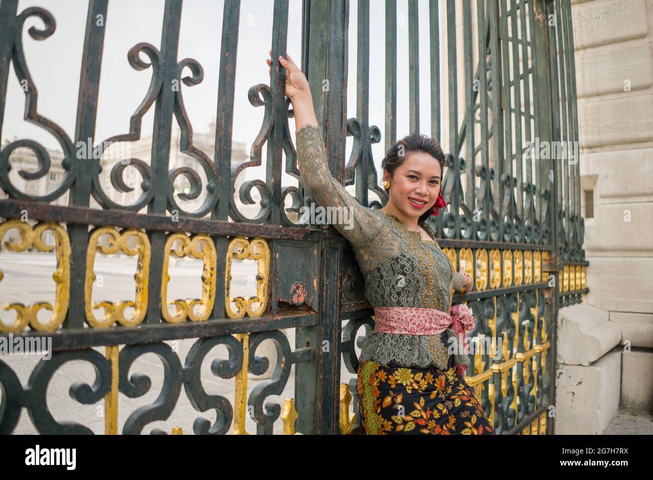 young happy Indonesian woman from Bali having vacation in Europe ...