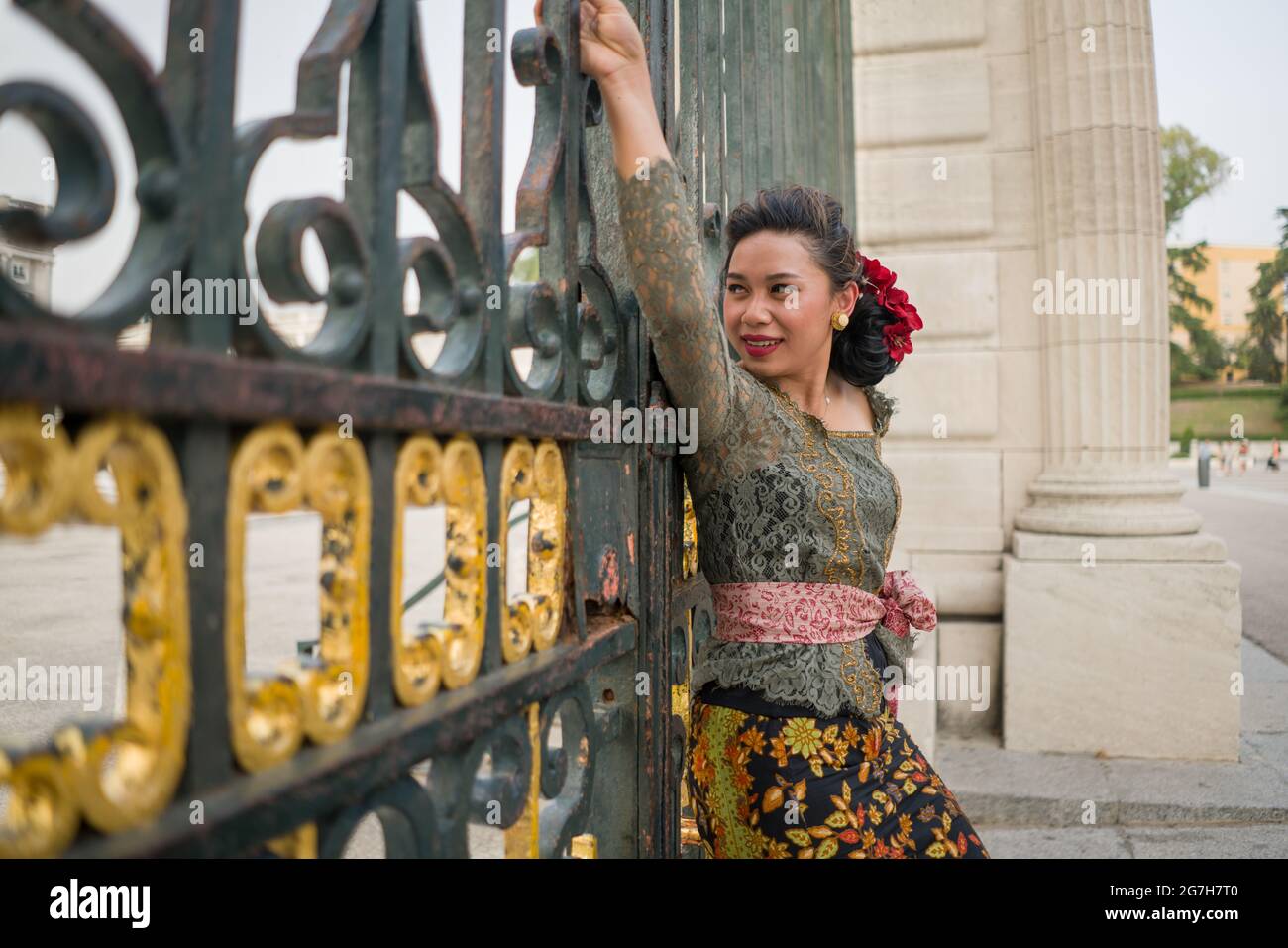 young happy Indonesian woman from Bali having vacation in Europe ...