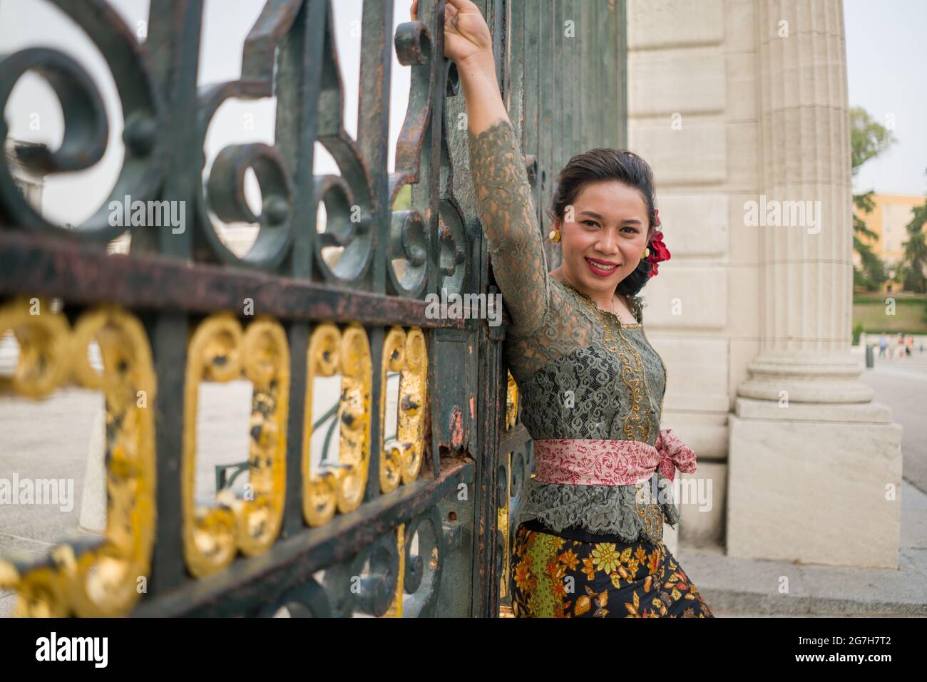 young happy Indonesian woman from Bali having vacation in Europe ...