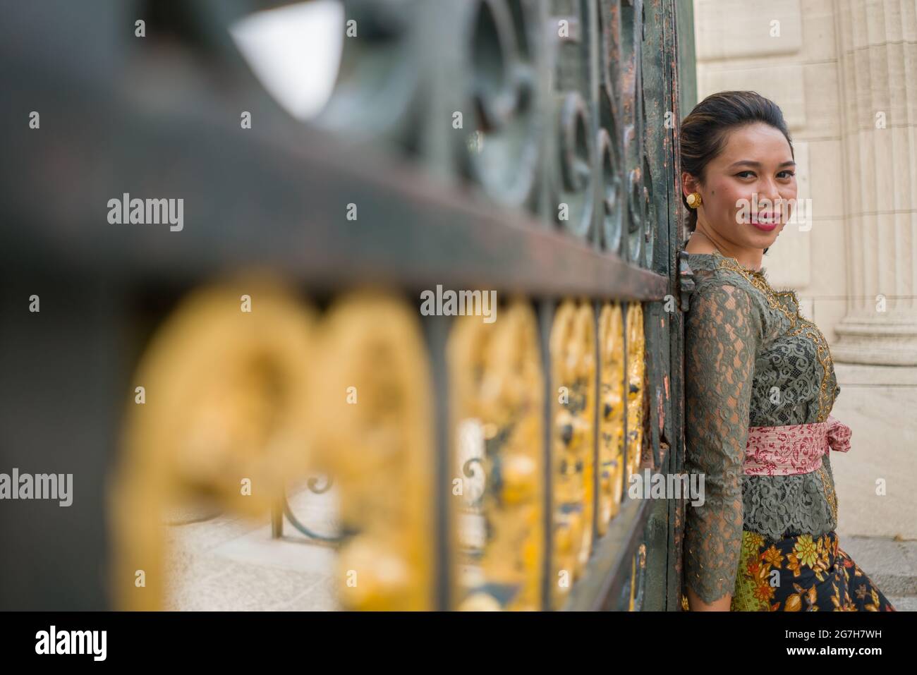 young happy Indonesian woman from Bali having vacation in Europe ...