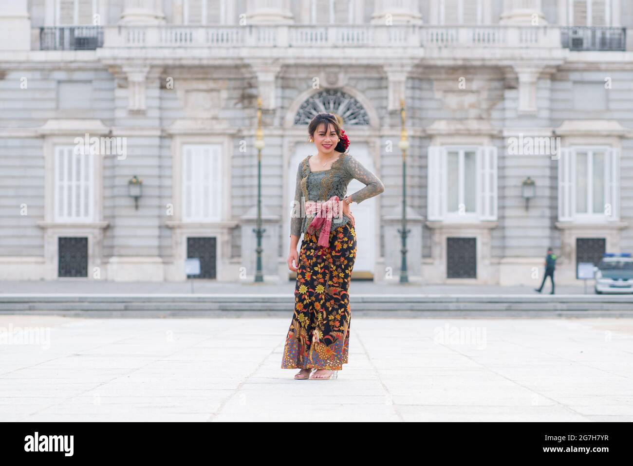young happy Indonesian woman from Bali having vacation in Europe ...