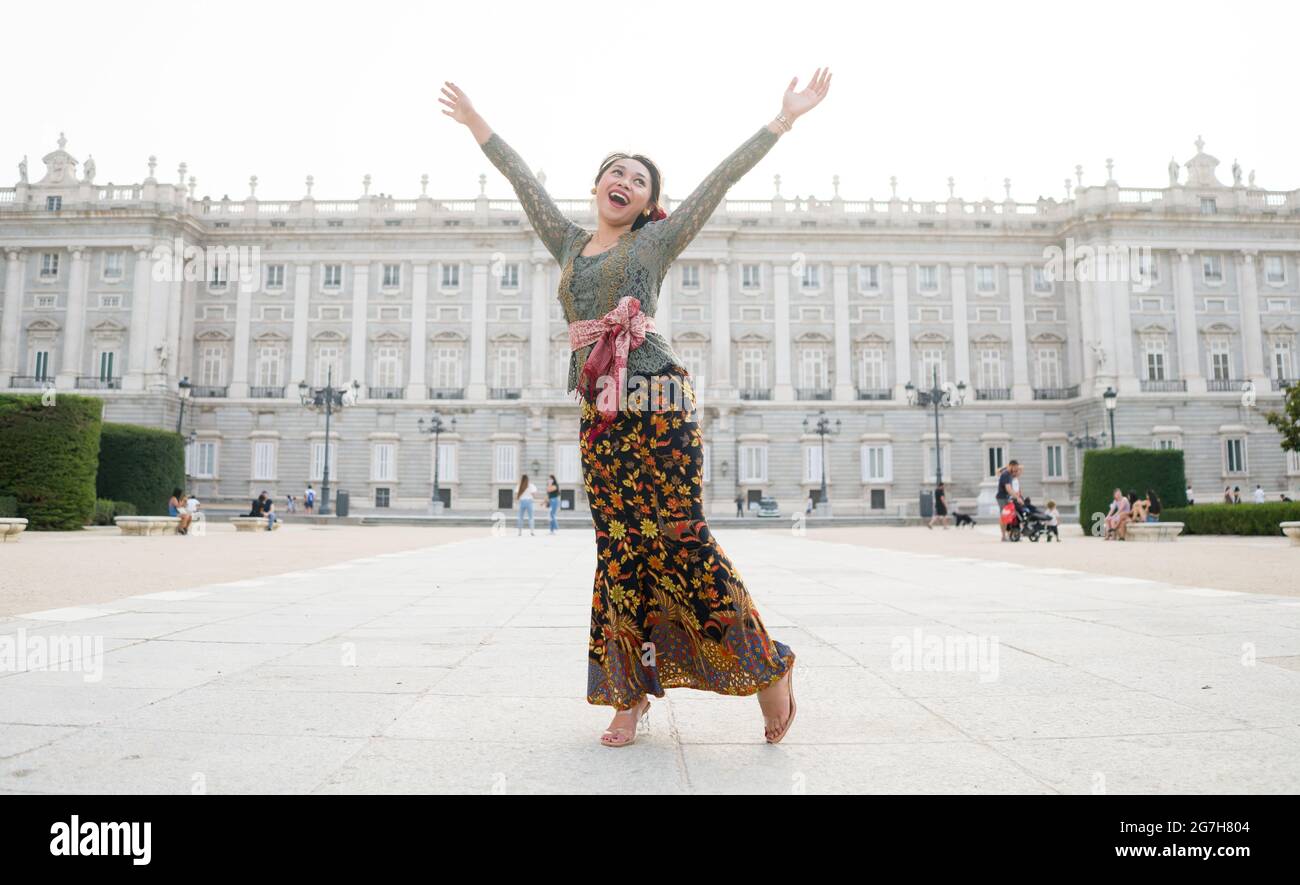 young happy Indonesian woman from Bali having vacation in Europe ...