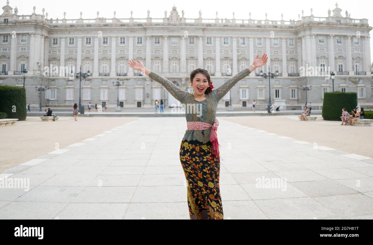 young happy Indonesian woman from Bali having vacation in Europe ...