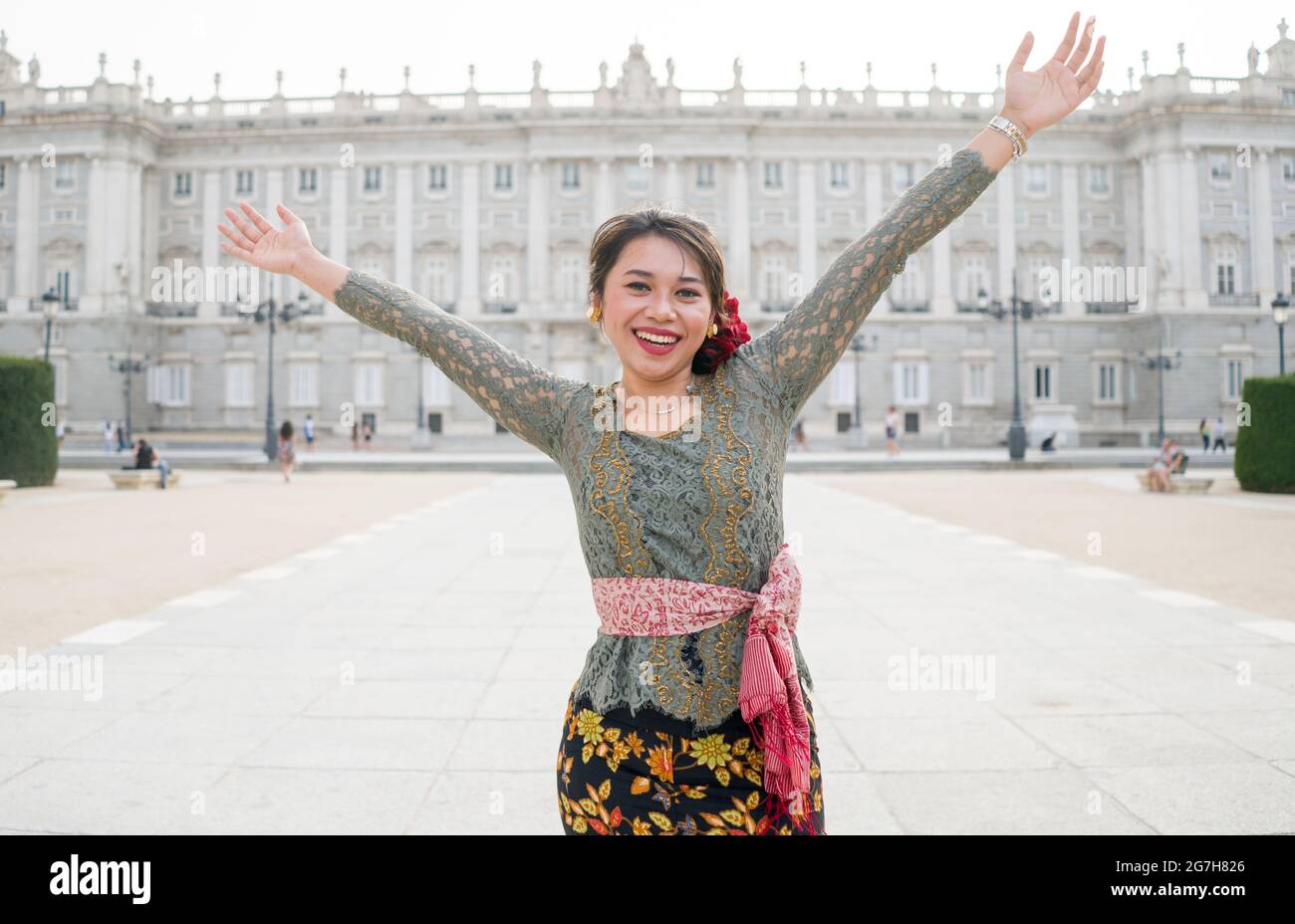 young happy Indonesian woman from Bali having vacation in Europe ...