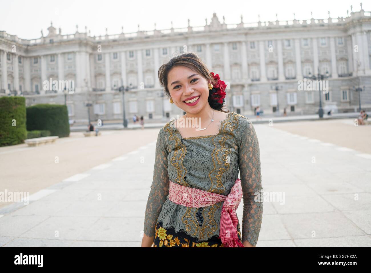 young happy Indonesian woman from Bali having vacation in Europe ...