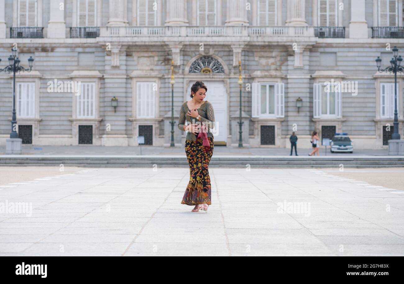 young happy Indonesian woman from Bali having vacation in Europe ...
