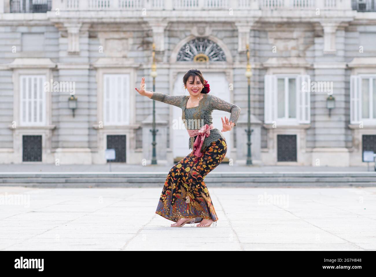 young happy Indonesian woman from Bali having vacation in Europe ...