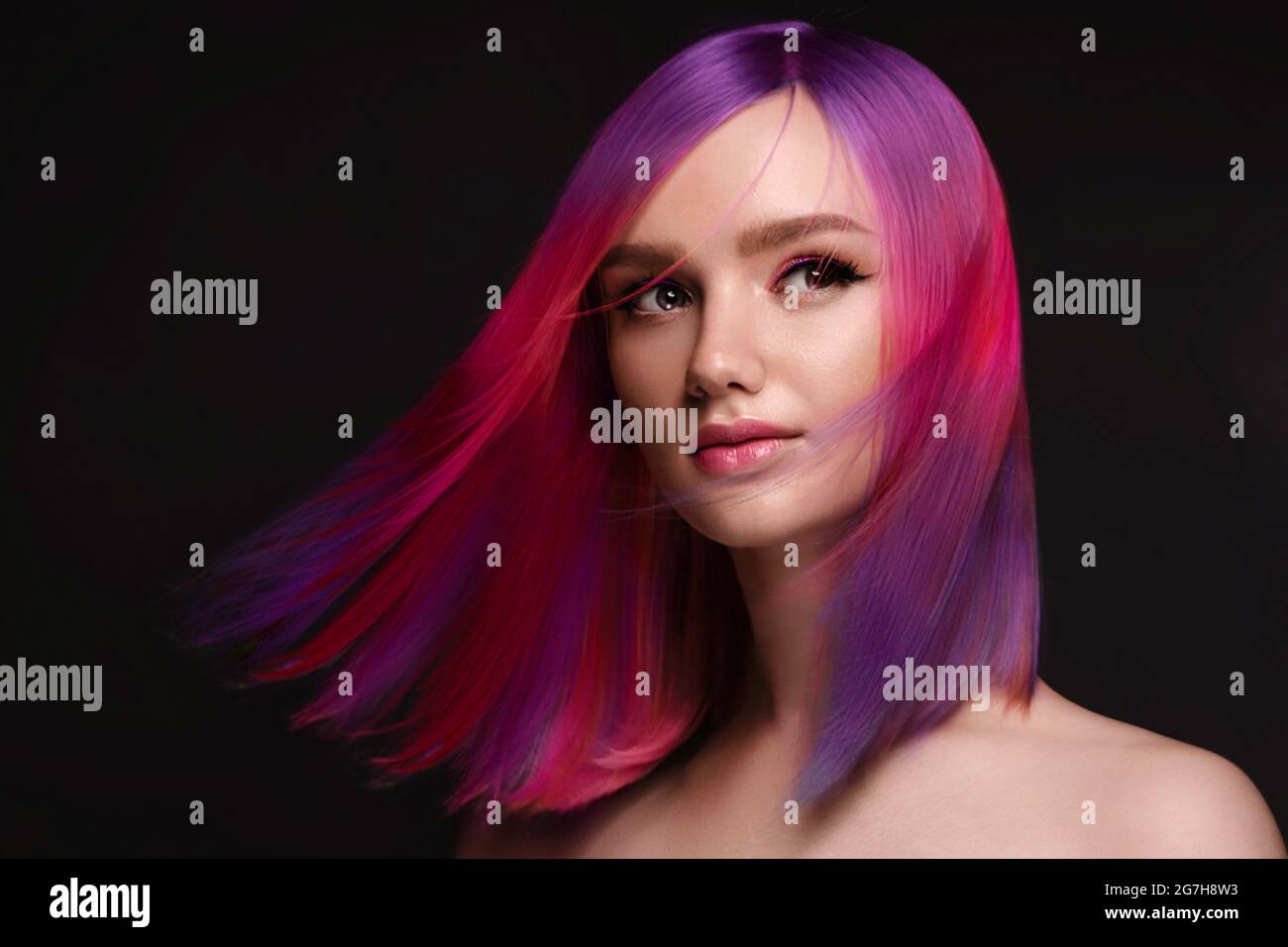 Beautiful woman with multi-colored hair and creative make up and ...