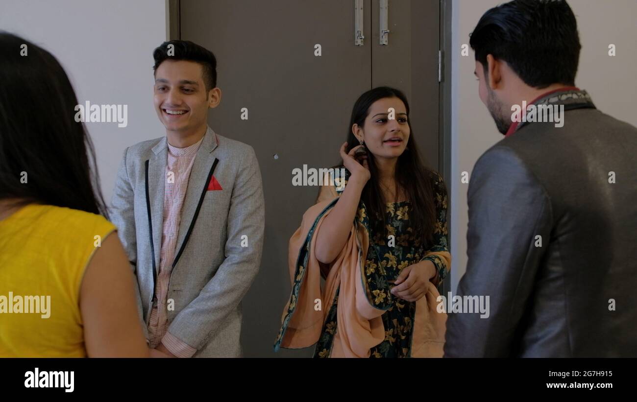 Group of young Indian friends having fun and talking to each other ...