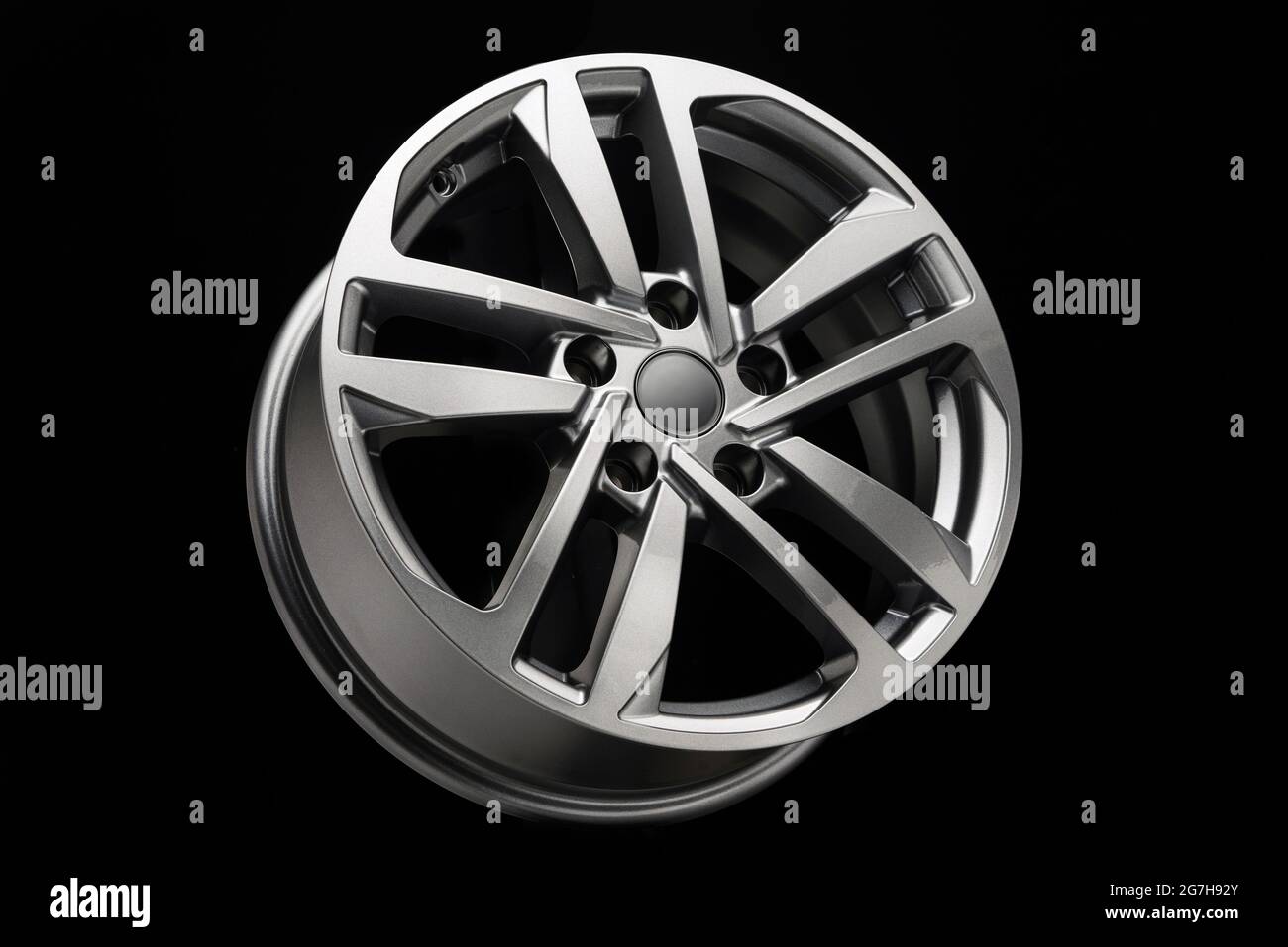 grey modern alloy wheel side view on black background Stock Photo - Alamy