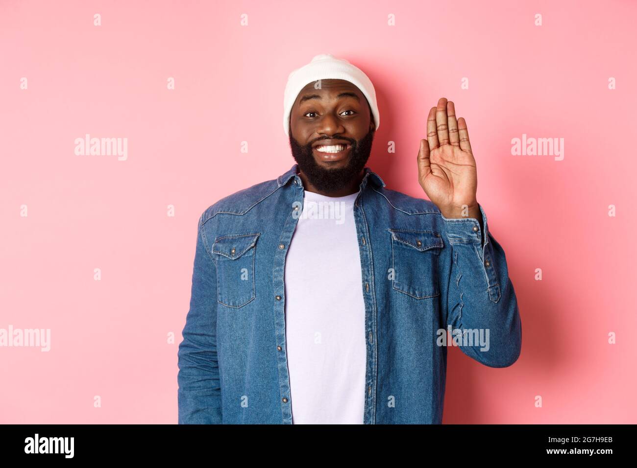 Friendly smiling Black man saying hello, waving hand, greeting you ...