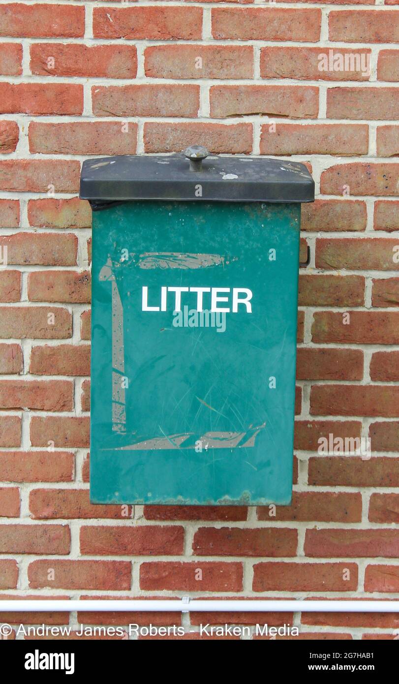 Old litter box leaning against a brick-walled building Stock Photo - Alamy