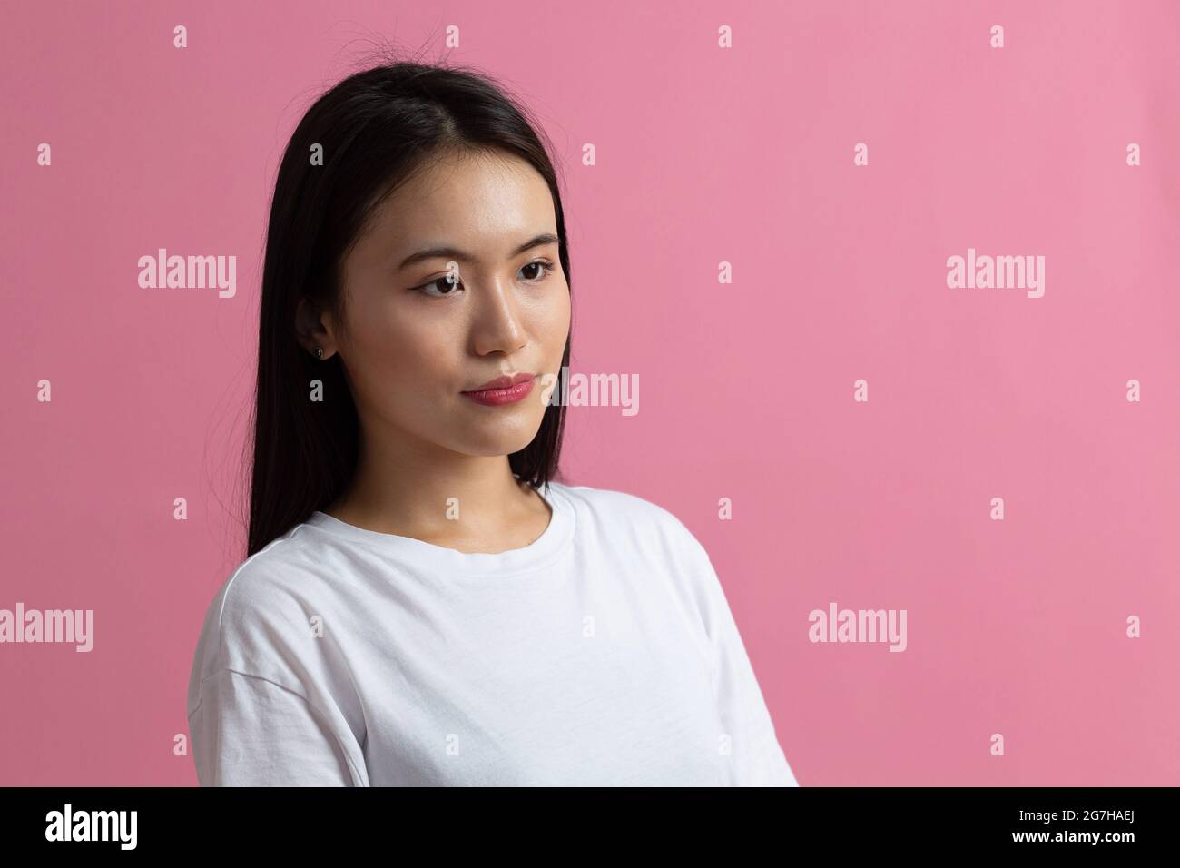Portrait half profile of asian woman on pink background Stock Photo - Alamy