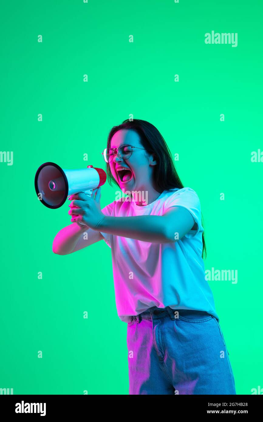 Portrait of young beautiful caucasian girl in casual clothes screaming ...