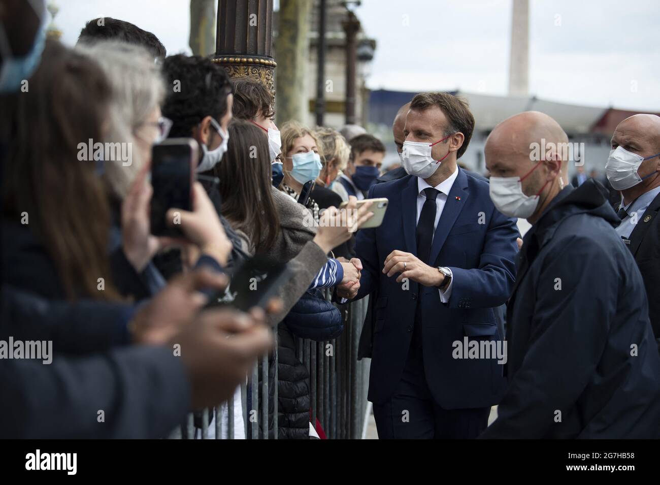 French President Emmanuel Macron (C) meets spectators at the end of the ...