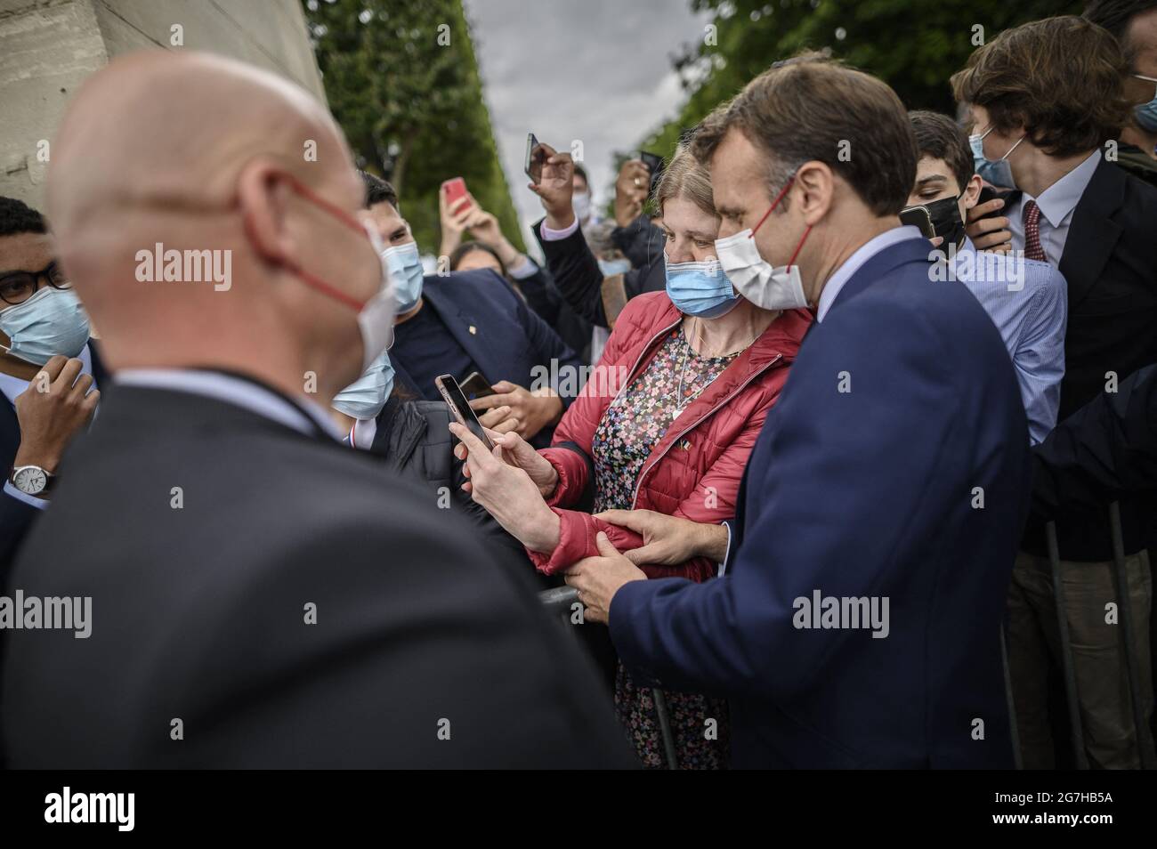 French President Emmanuel Macron (C) meets spectators at the end of the ...
