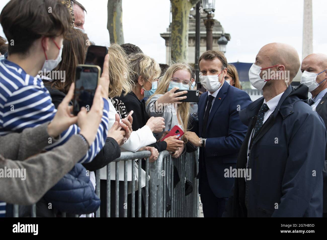French President Emmanuel Macron (C) meets spectators at the end of the ...