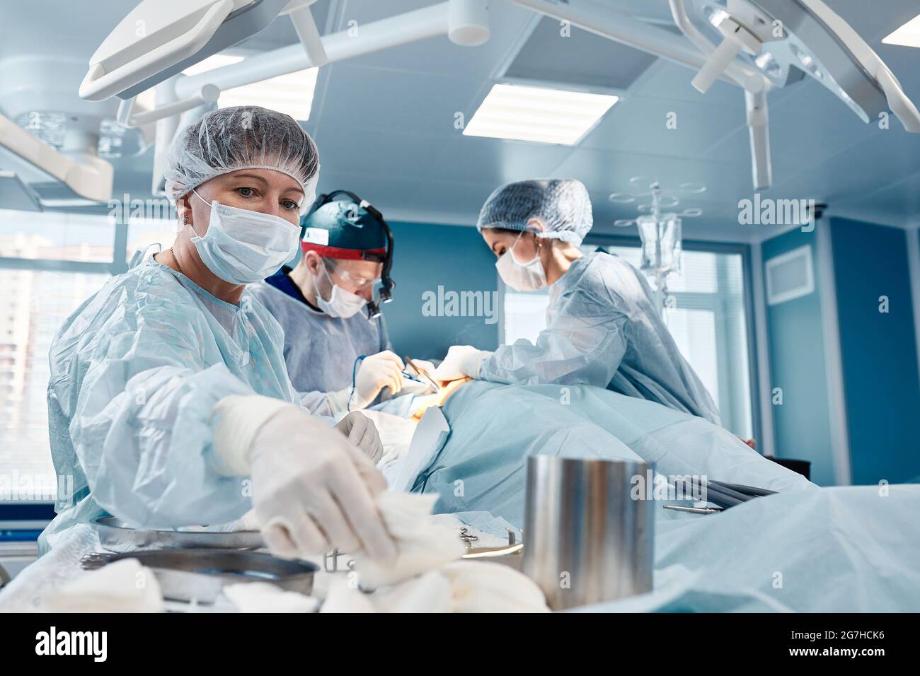 cosmetic liposuction surgery in actual operating room setting showing ...