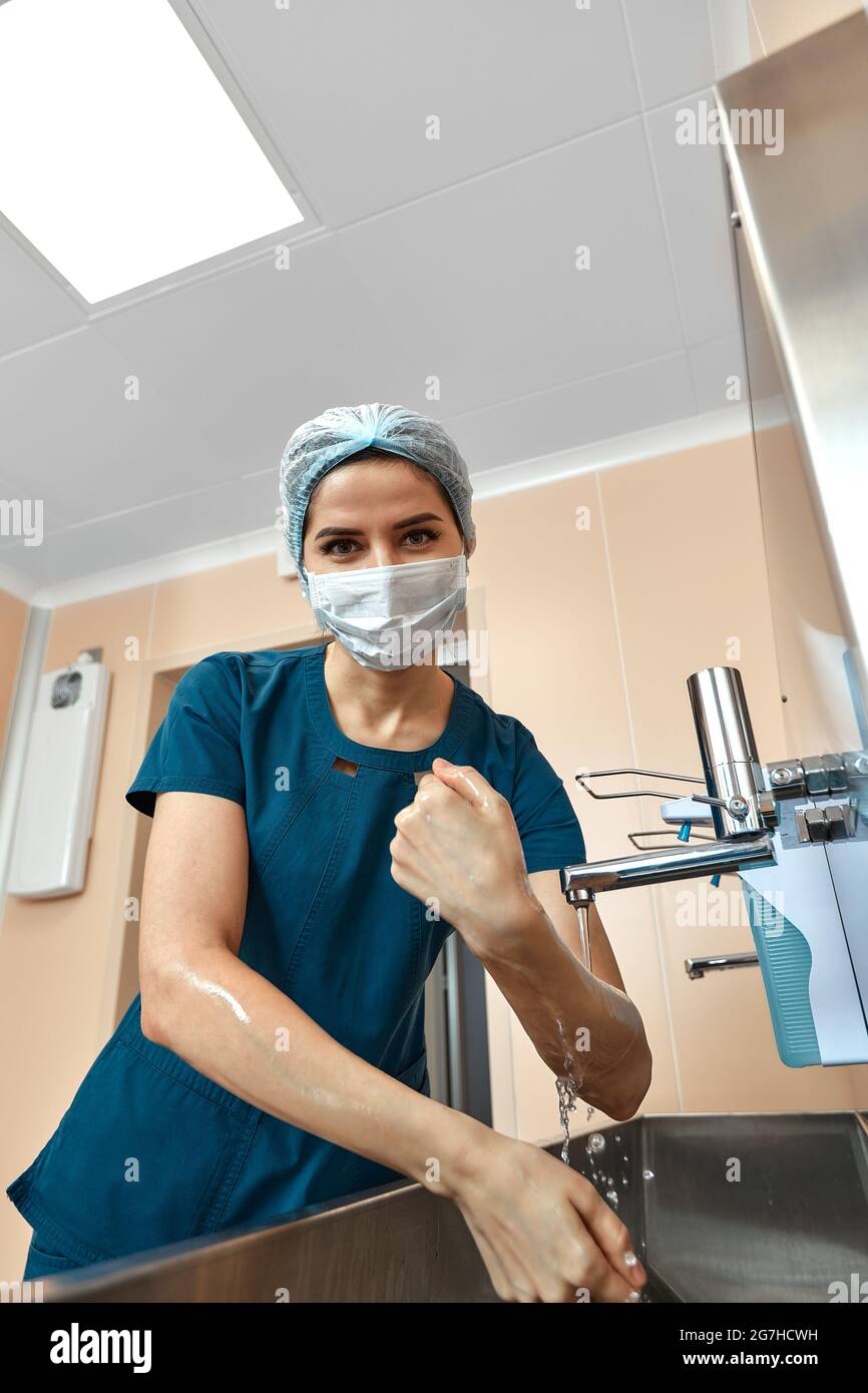 Woman doctor, washing her hands close-up, in the preoperative unit ...