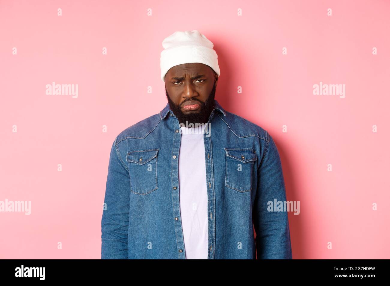 Disappointed and sad Black man, sulking and whining, looking at camera ...