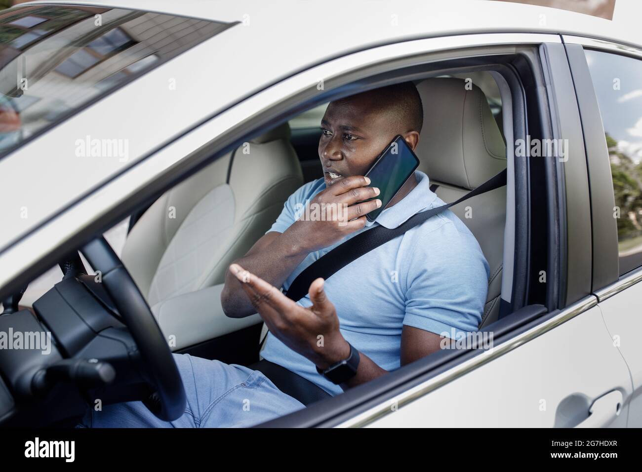Safety driving and modern gadgets concept. Angry black man driver ...